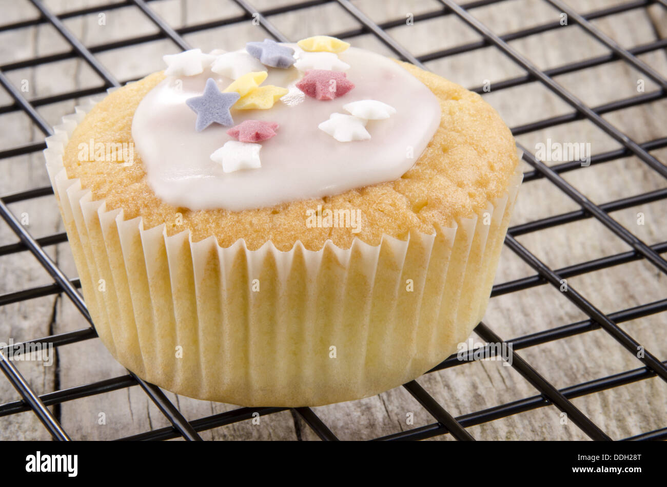 cupcake with icing and sugar stars Stock Photo - Alamy