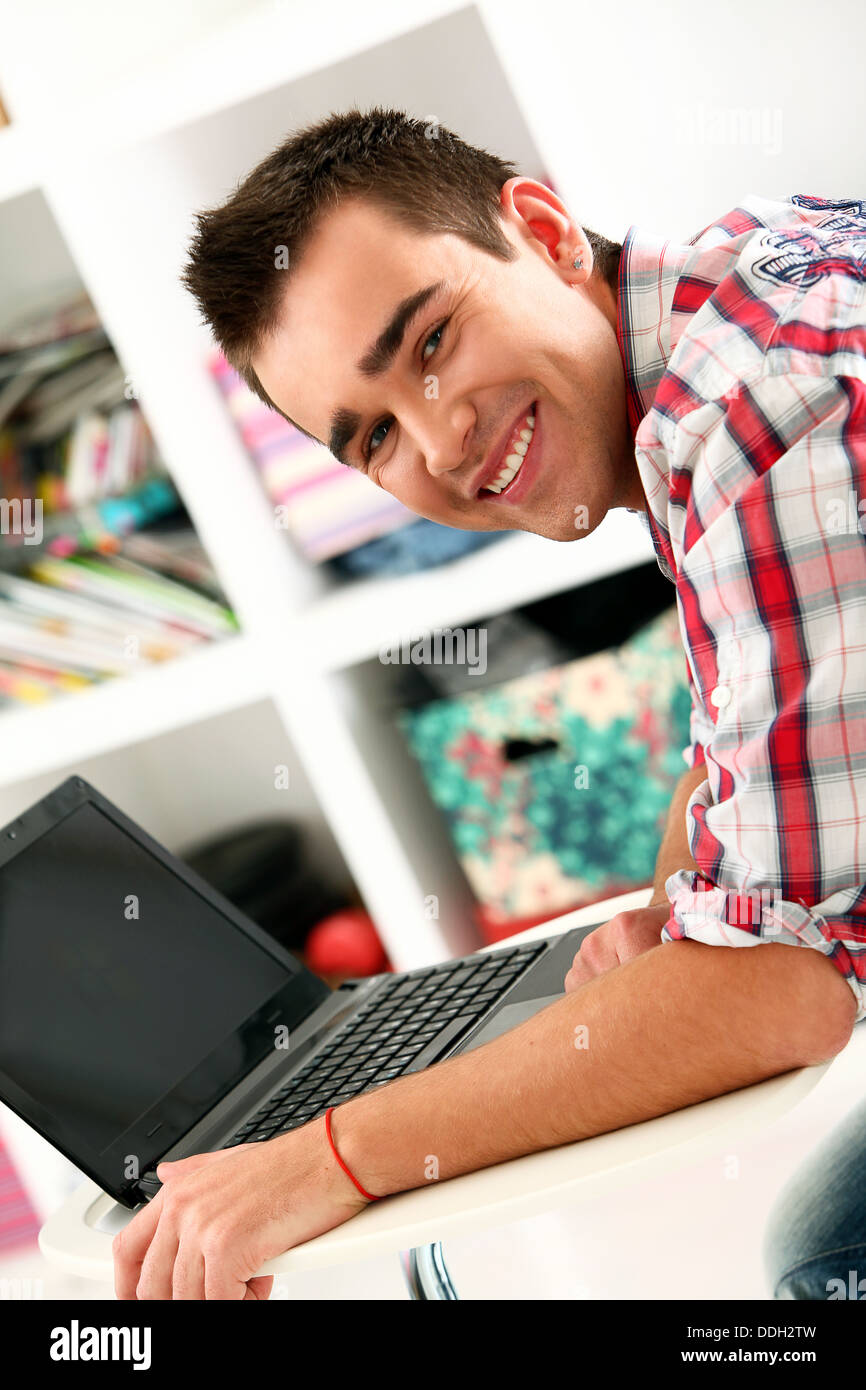 Handsome man working with laptop at home Stock Photo - Alamy