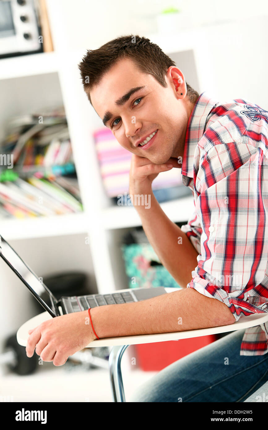 Handsome man working with laptop at home Stock Photo - Alamy