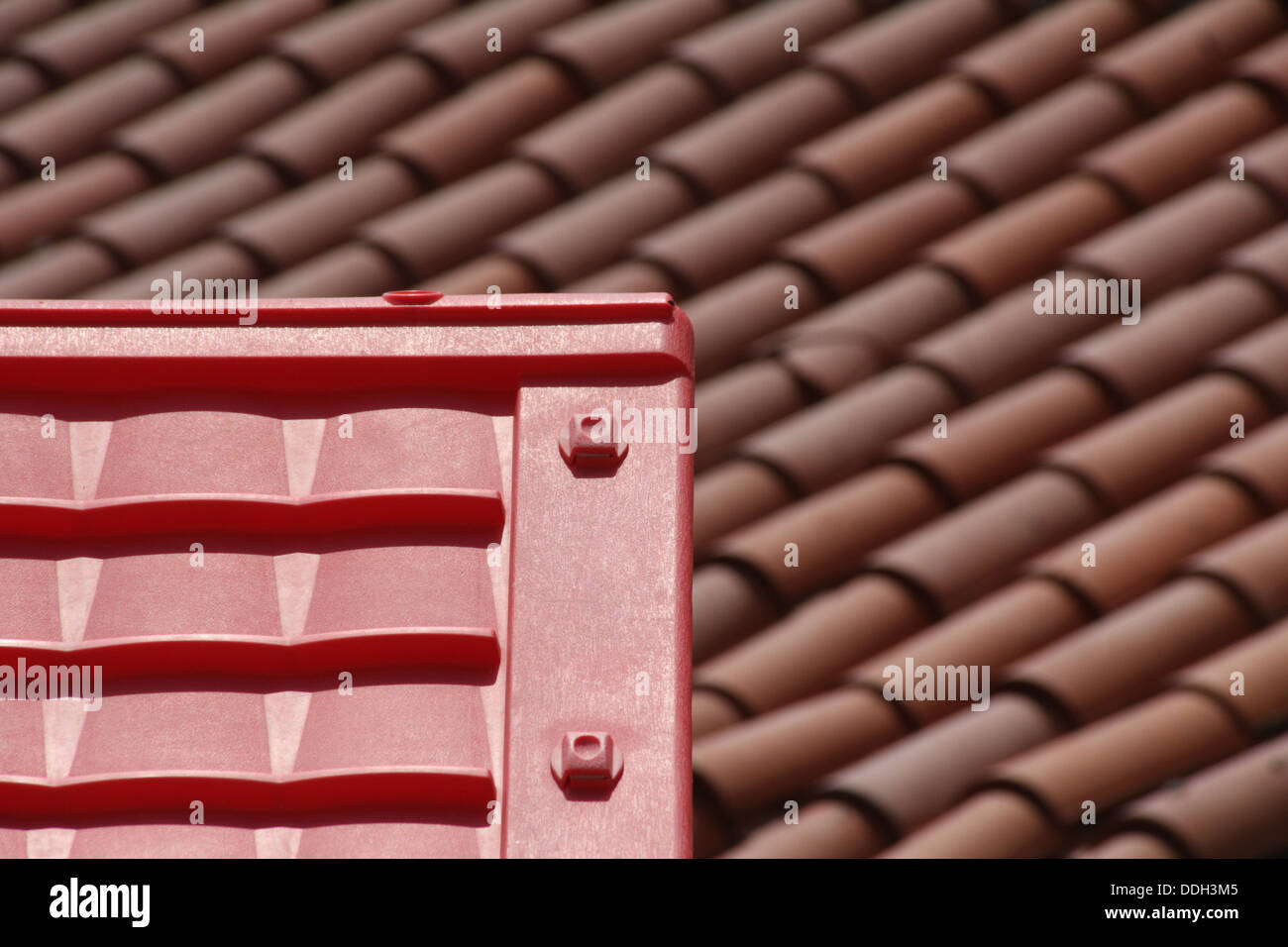 plastic toy house roof and real tiled roof Stock Photo - Alamy
