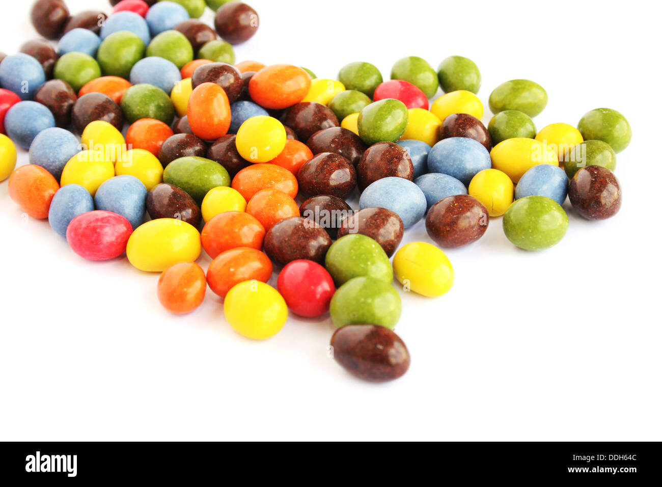 Colorful candies with raisins and peanuts isolated on white background ...