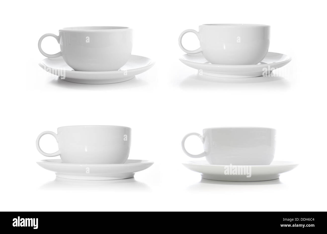 Four White Cups on a white isolated background Stock Photo - Alamy