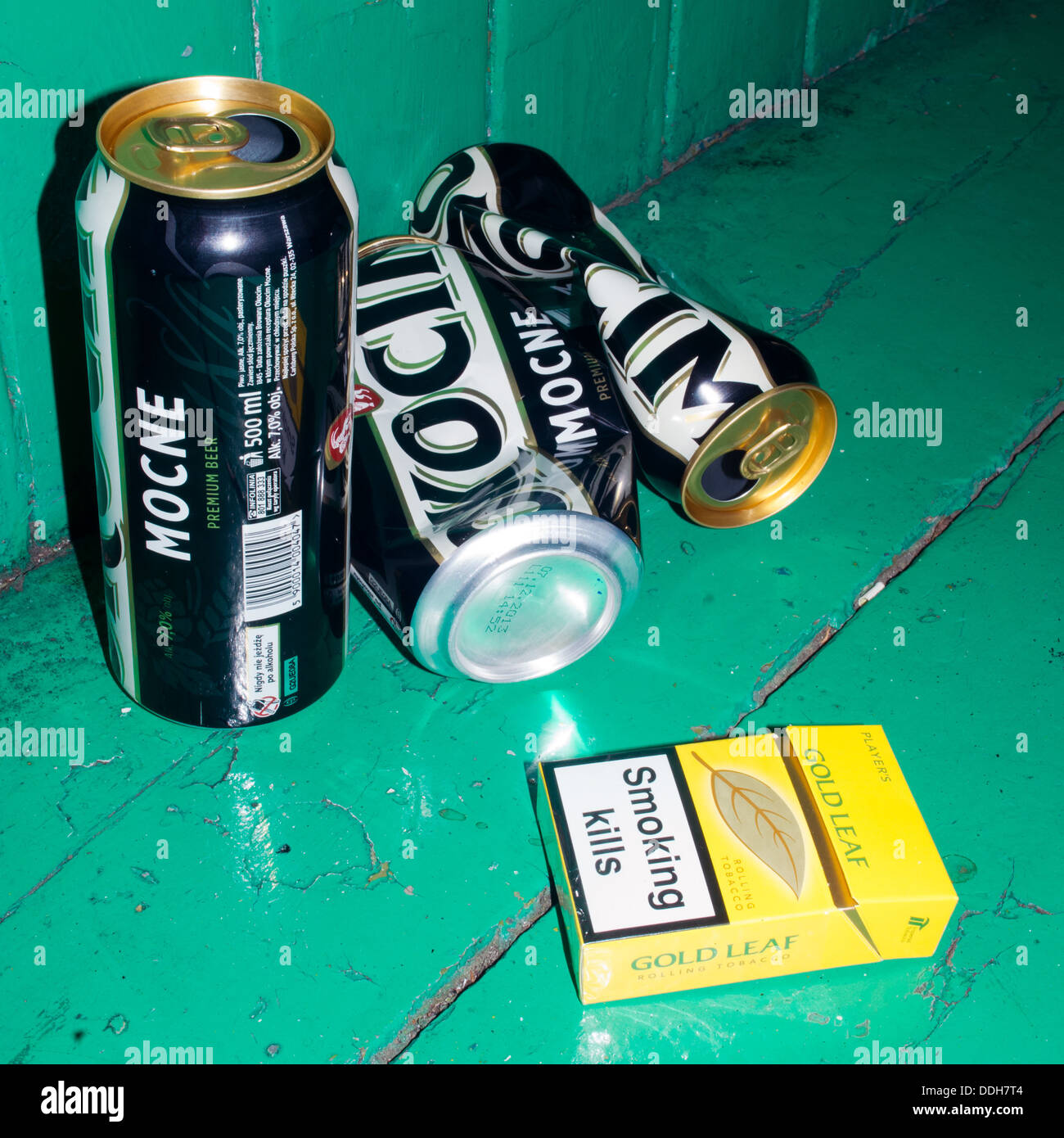 Empty beer cans on park bench Stock Photo - Alamy