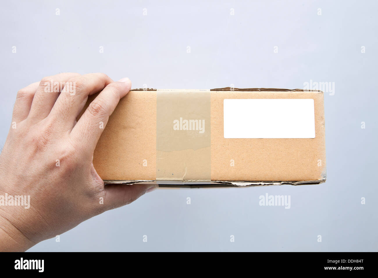 close up hand holding brown box Stock Photo - Alamy