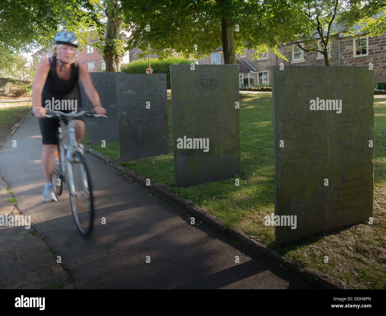 Woman riding bike woman riding bicycle tombstones hi-res stock ...