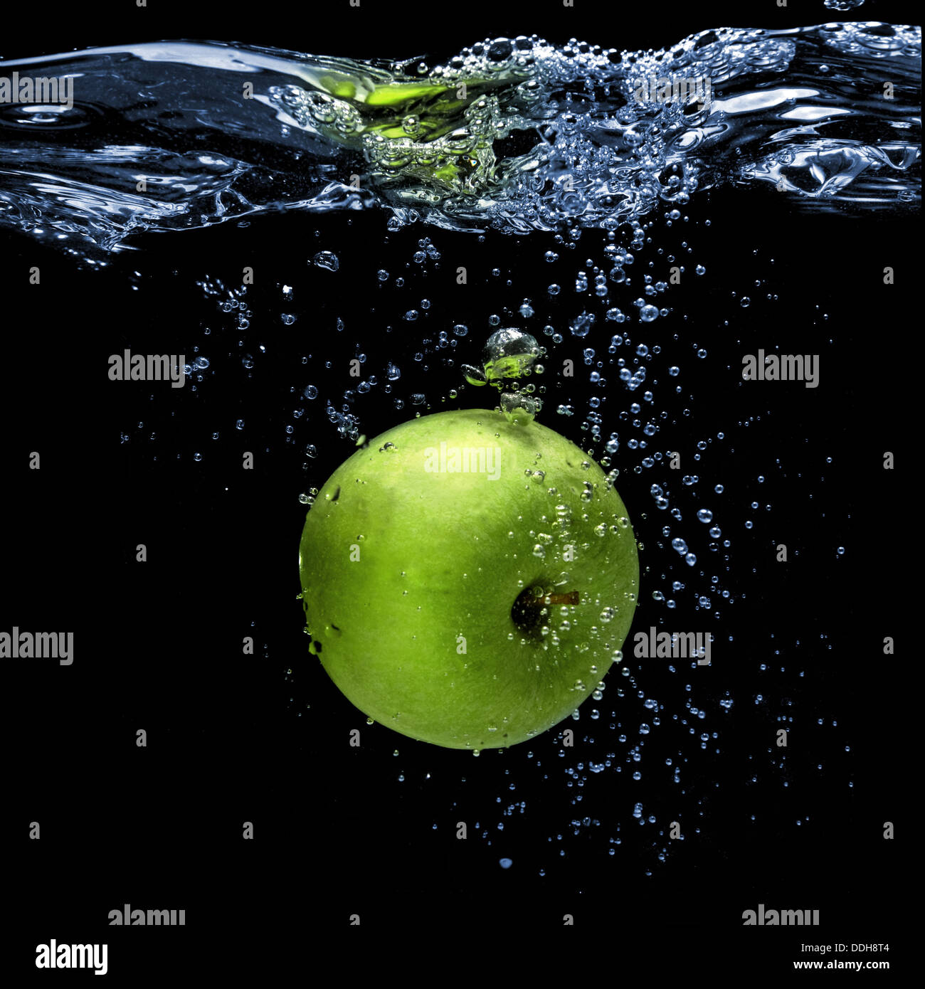 green apple dropped into water with splash isolated on black Stock ...