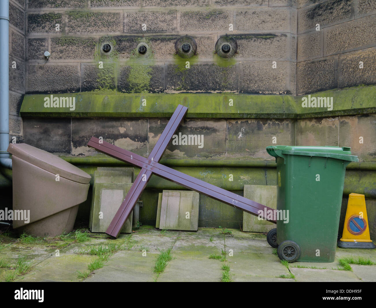 Crucifix at a church that has been thrown out in the trash symbolizing ...