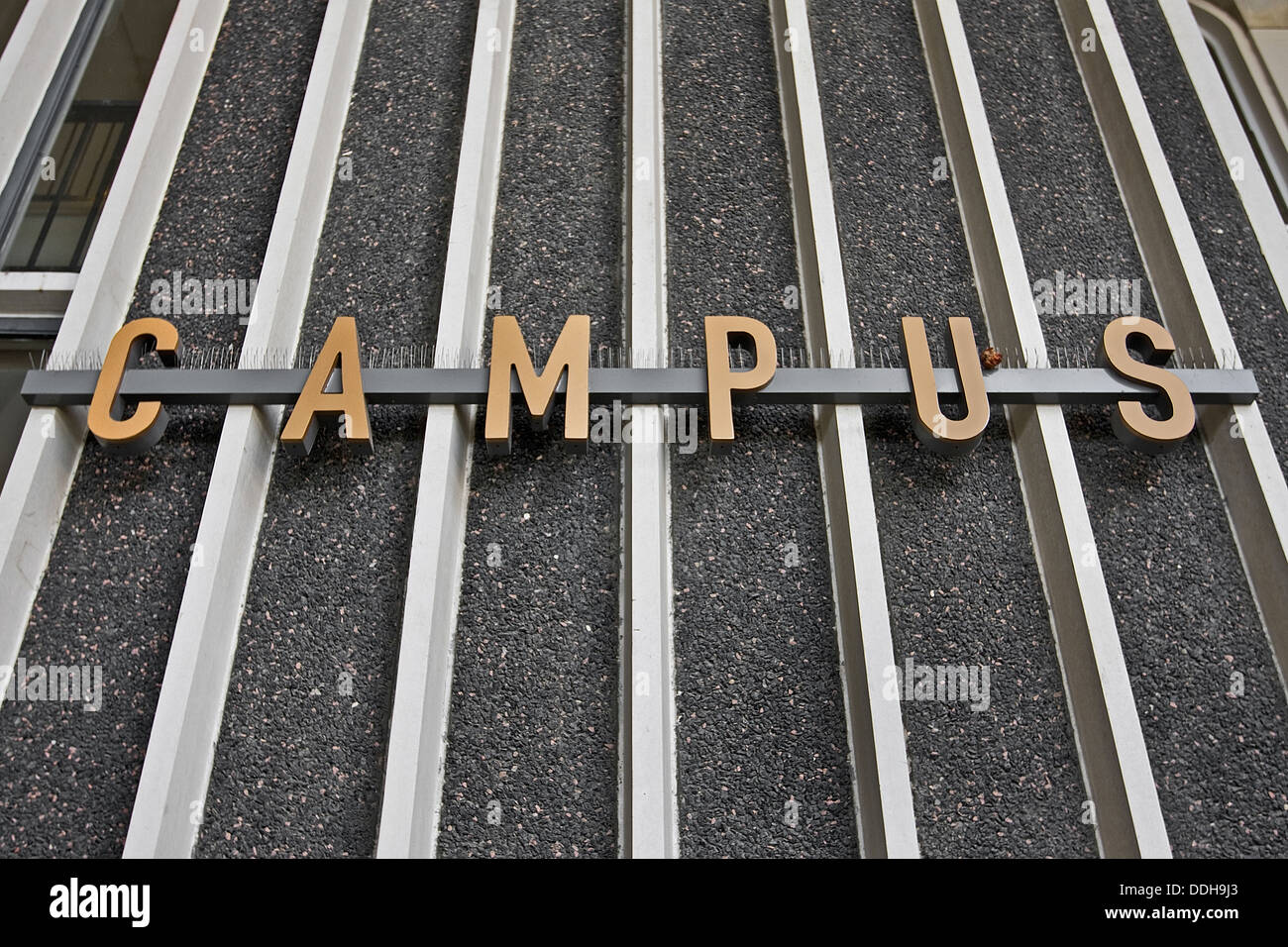 campus sign on the steel rails and concrete wall Stock Photo - Alamy