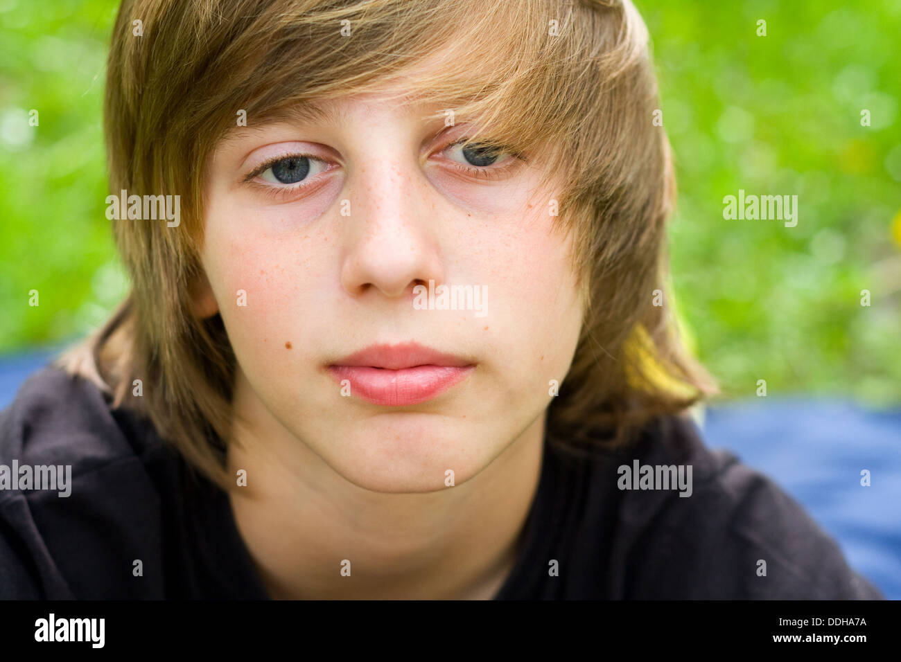 European school-age boy with blue eyes looking directly at the camera ...