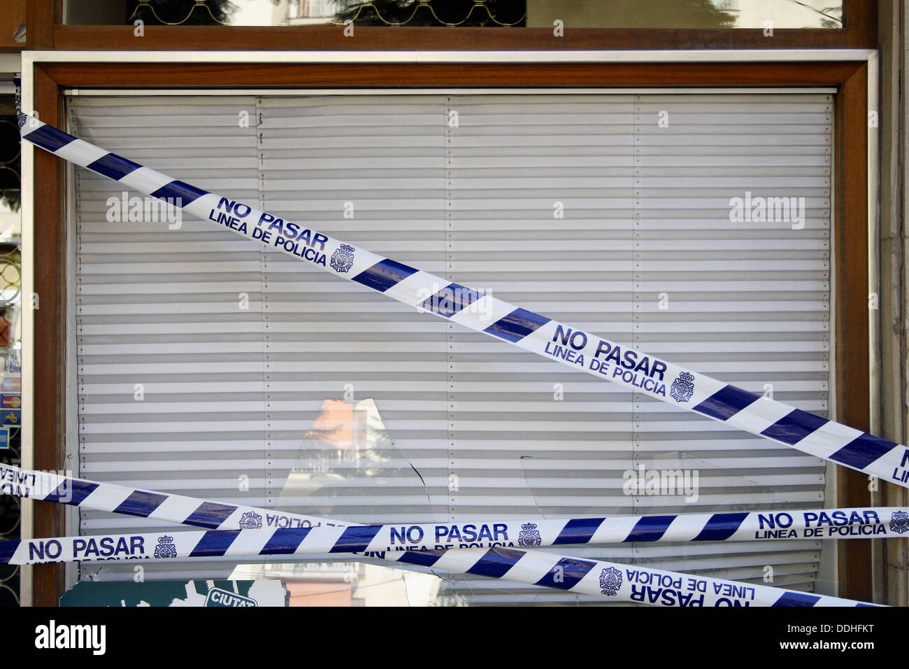 Broken window-shop with police tape Stock Photo - Alamy