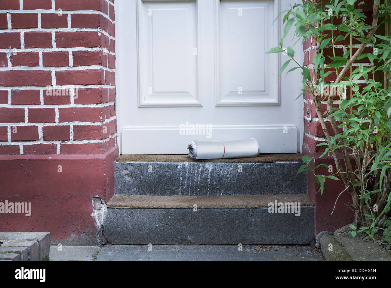 Newspaper on doorstep Stock Photo - Alamy