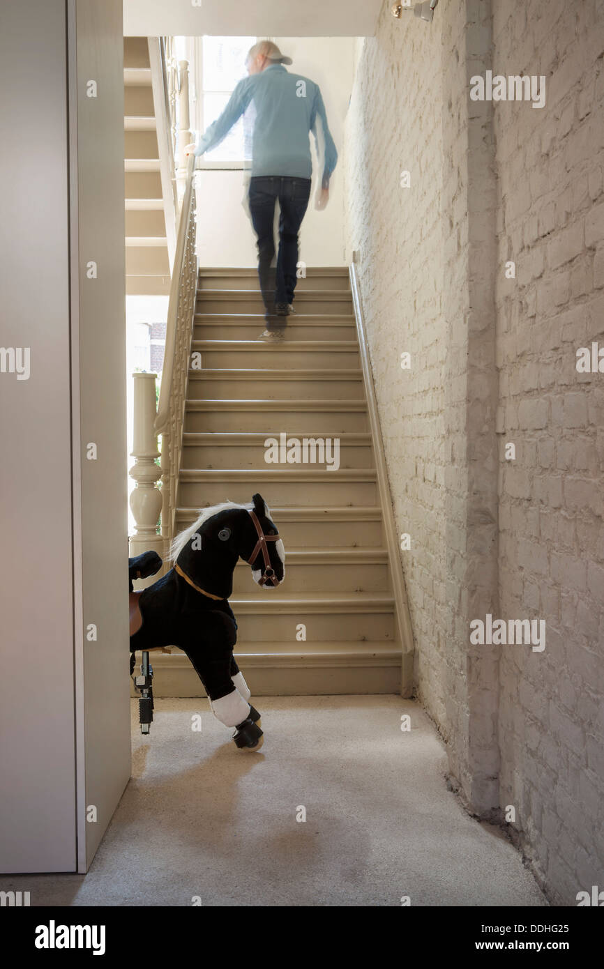 Mature man moving up staircase Stock Photo - Alamy