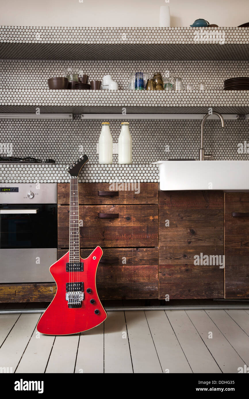 Interior of kitchen with electric guitar Stock Photo - Alamy