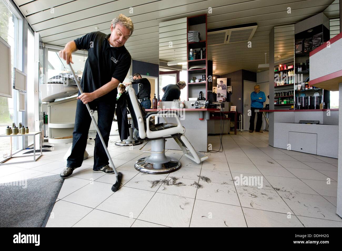 Barber cleaning floor hairdresser salon hi-res stock photography and ...