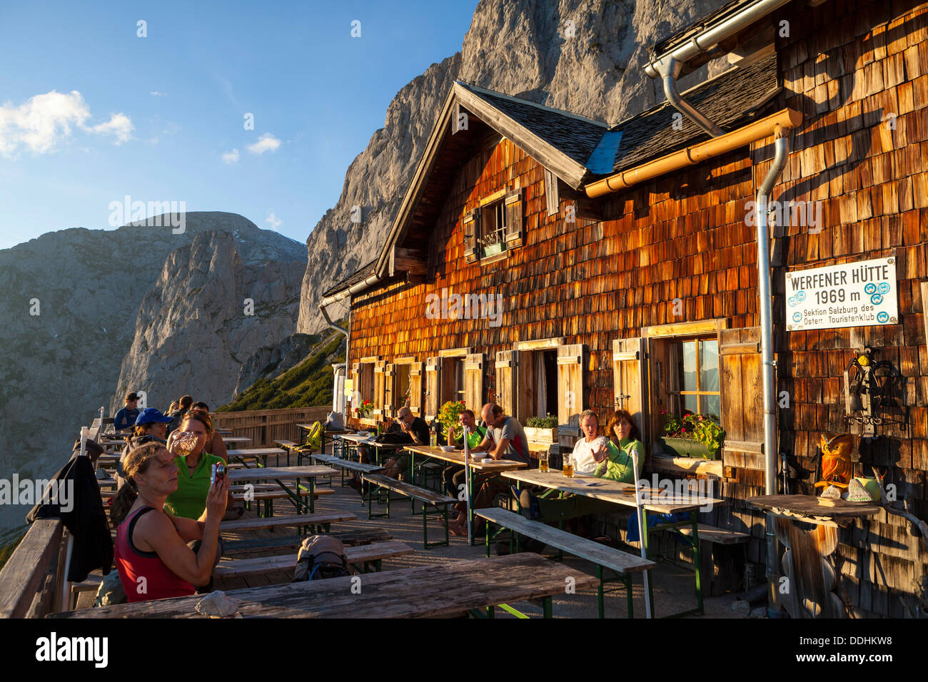 Terrace of Werfener Huette, refuge and inn, in the evening sun Stock ...