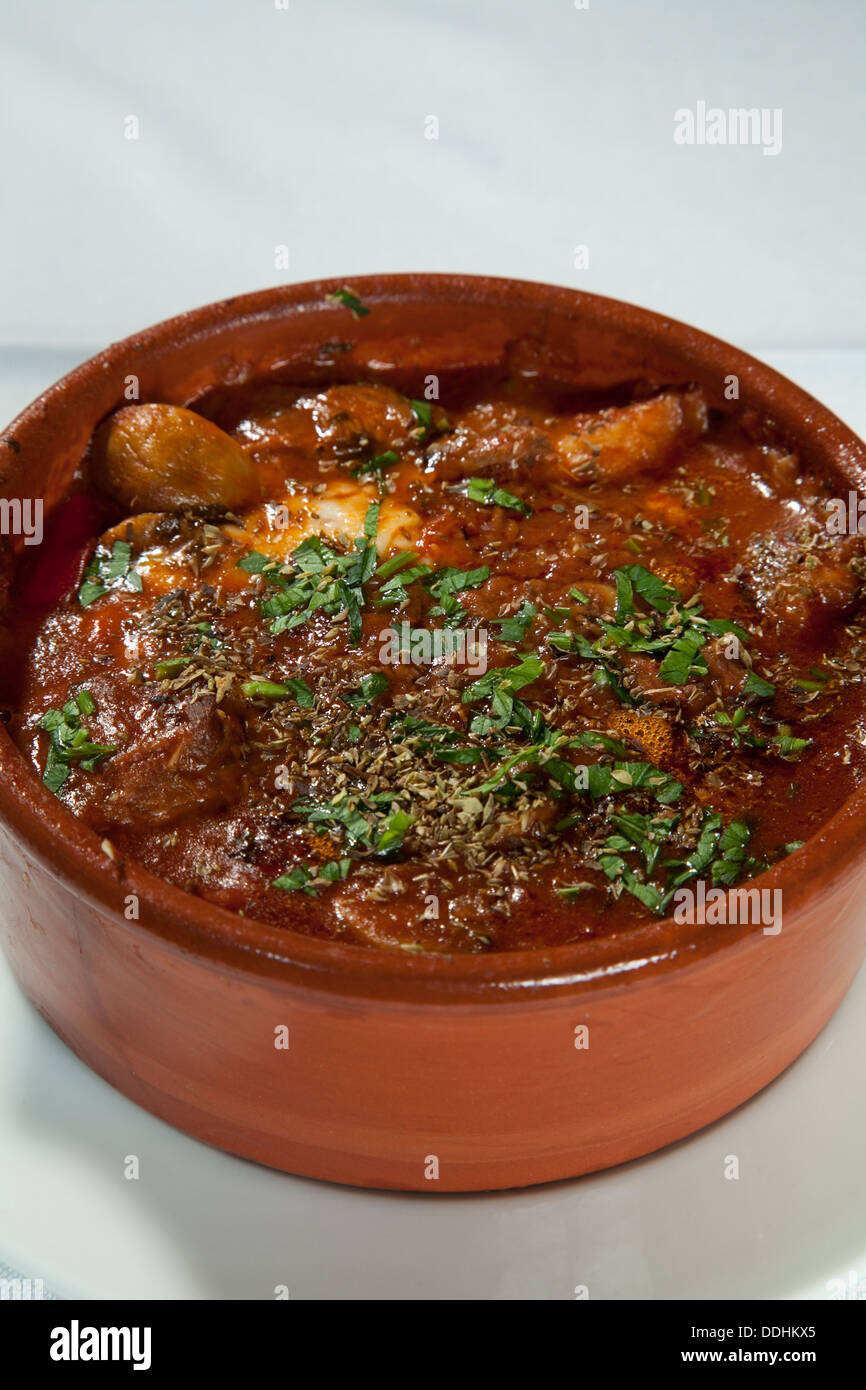 Chicken meat with potatoes and cheese cooked in clay pot in the oven ...