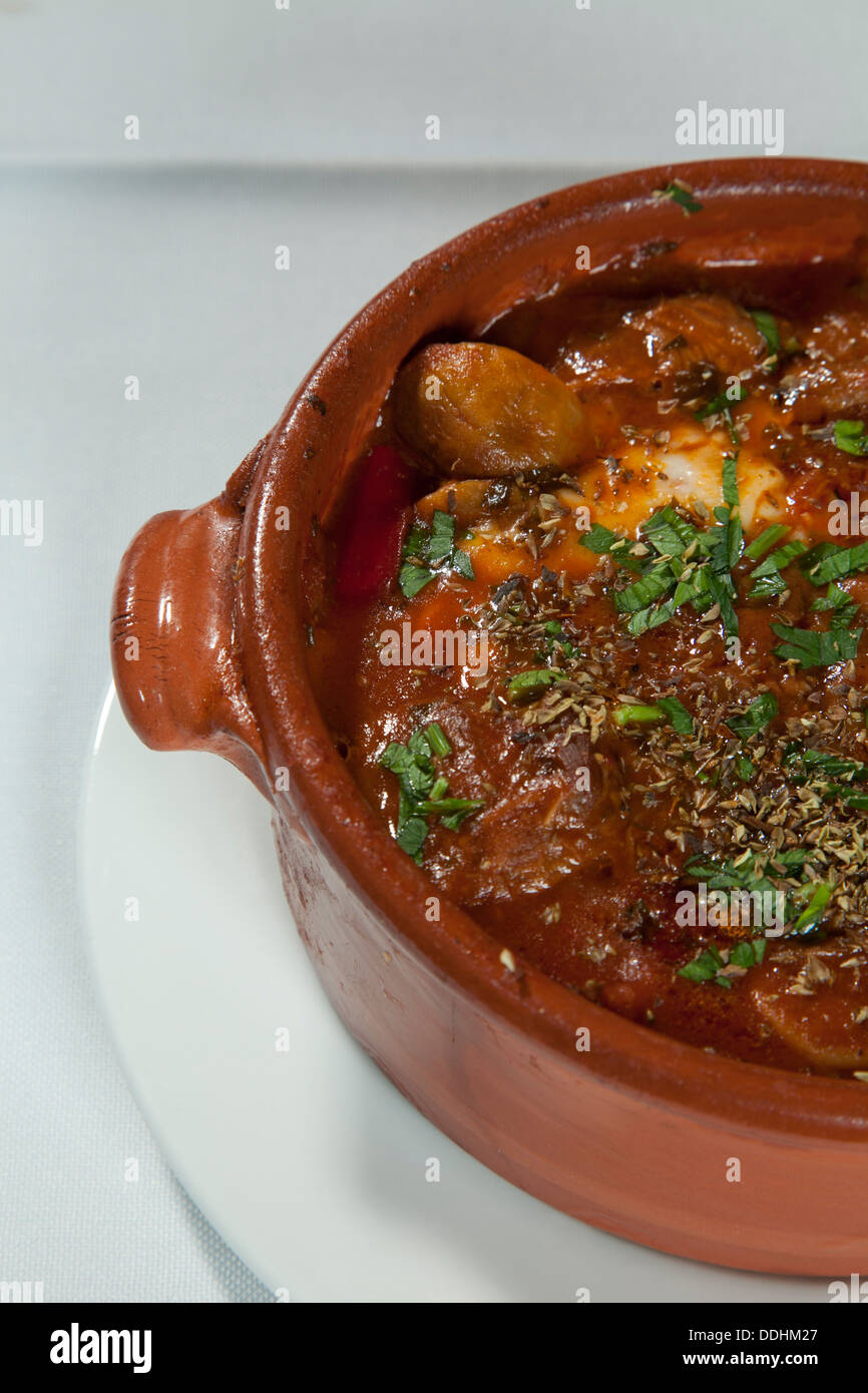 Chicken meat with potatoes and cheese cooked in clay pot in the oven ...