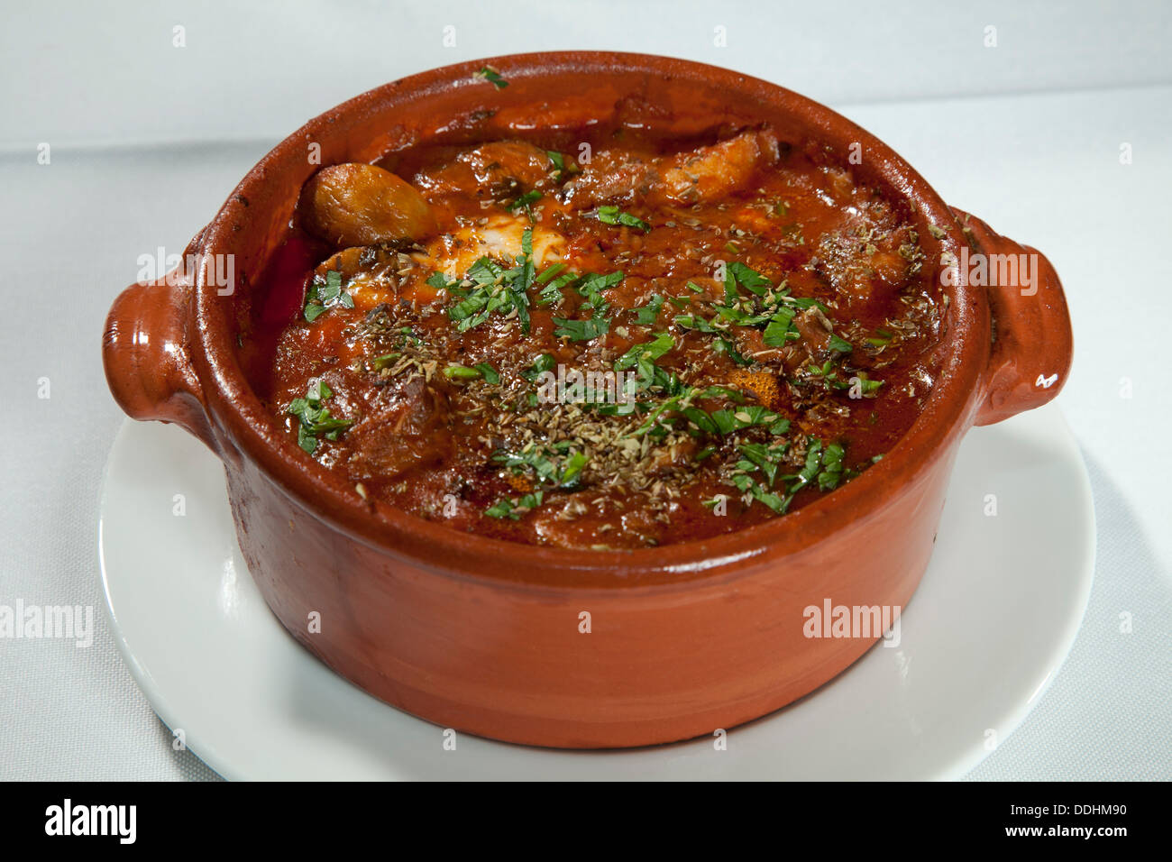 Chicken meat with potatoes and cheese cooked in clay pot in the oven ...