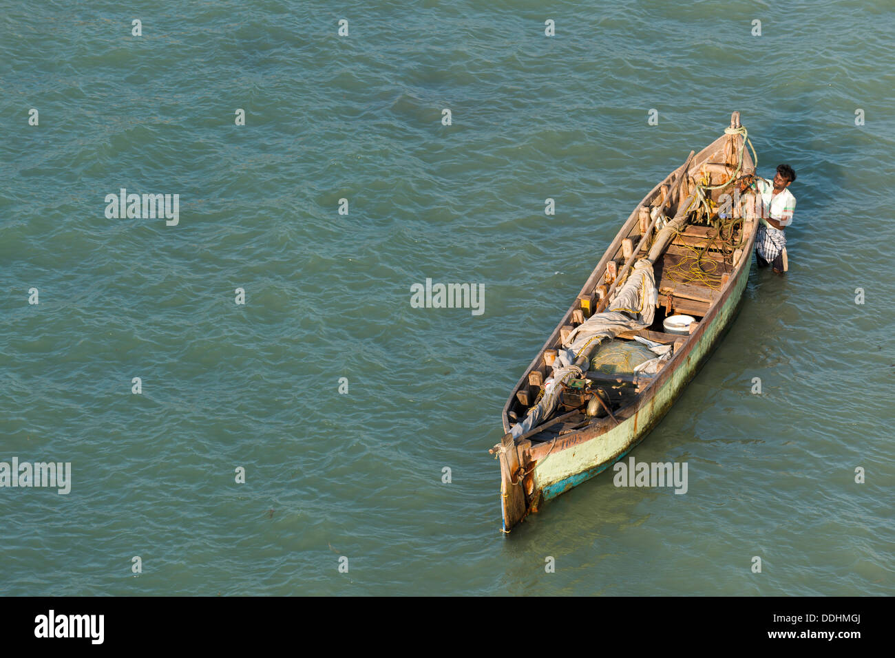 Fisherman with his fishing boat Stock Photo - Alamy