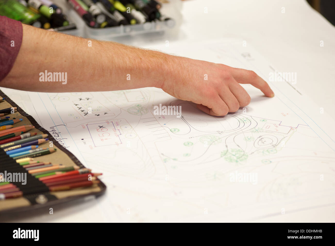 Hand sorting out design on a blueprint map Stock Photo - Alamy