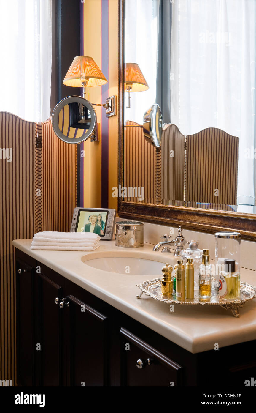 Gentleman's bathroom with limestone wash basin and toiletries Stock ...