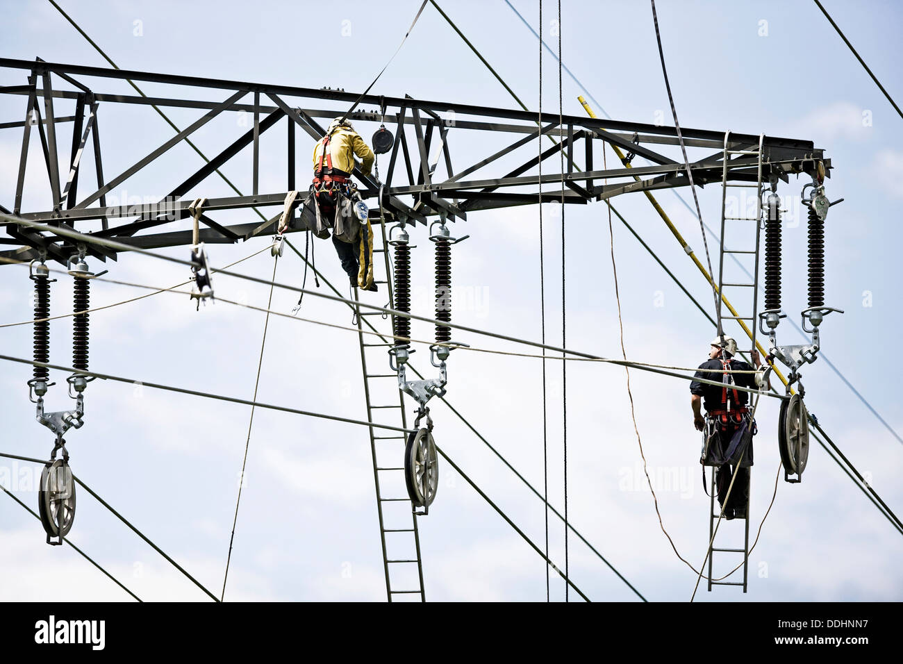 High-voltage service technicians installing a new high voltage power ...