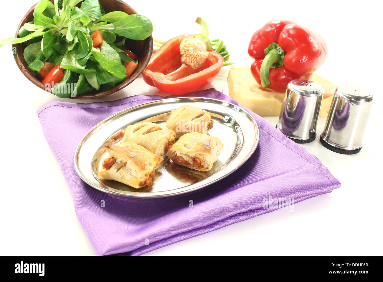 Puff pastry with bell peppers and cheese filling on a light background ...