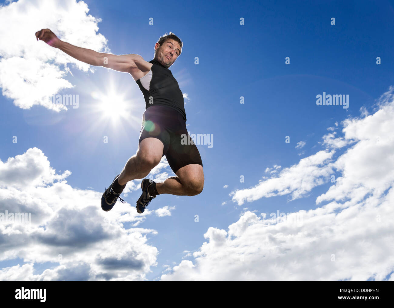Germany, Mature man doing long jump Stock Photo - Alamy