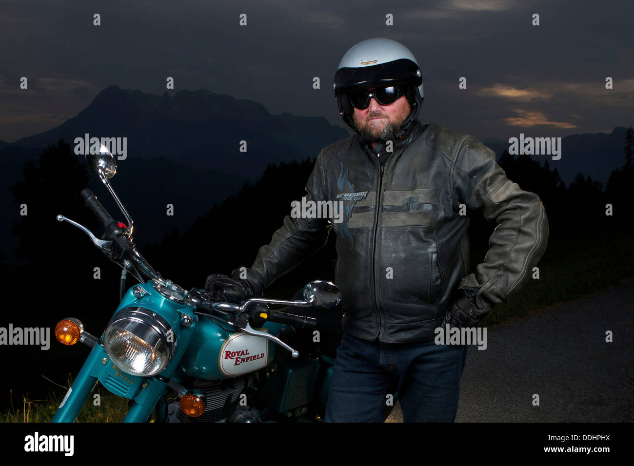 Motorcycle rider standing next to his motorbike Stock Photo - Alamy
