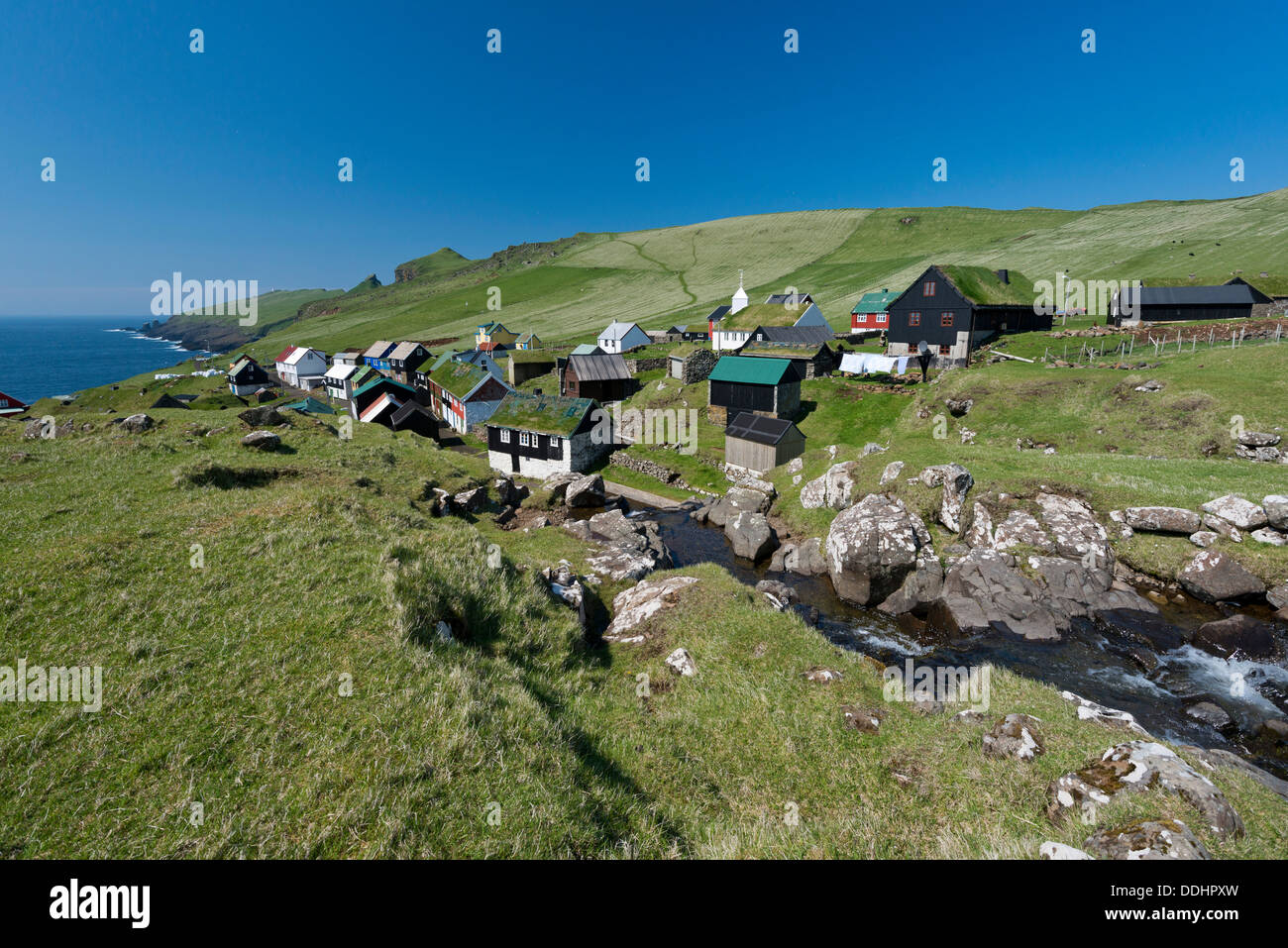 Village with houses mostly in the traditional Faroese style, wood on a ...
