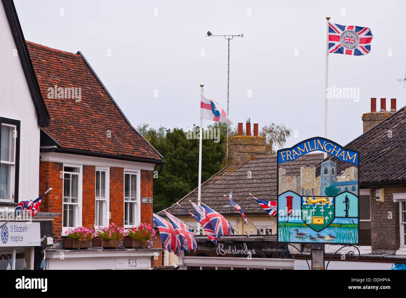 town sign Framlingham market Hill Suffolk with flags for arm services ...