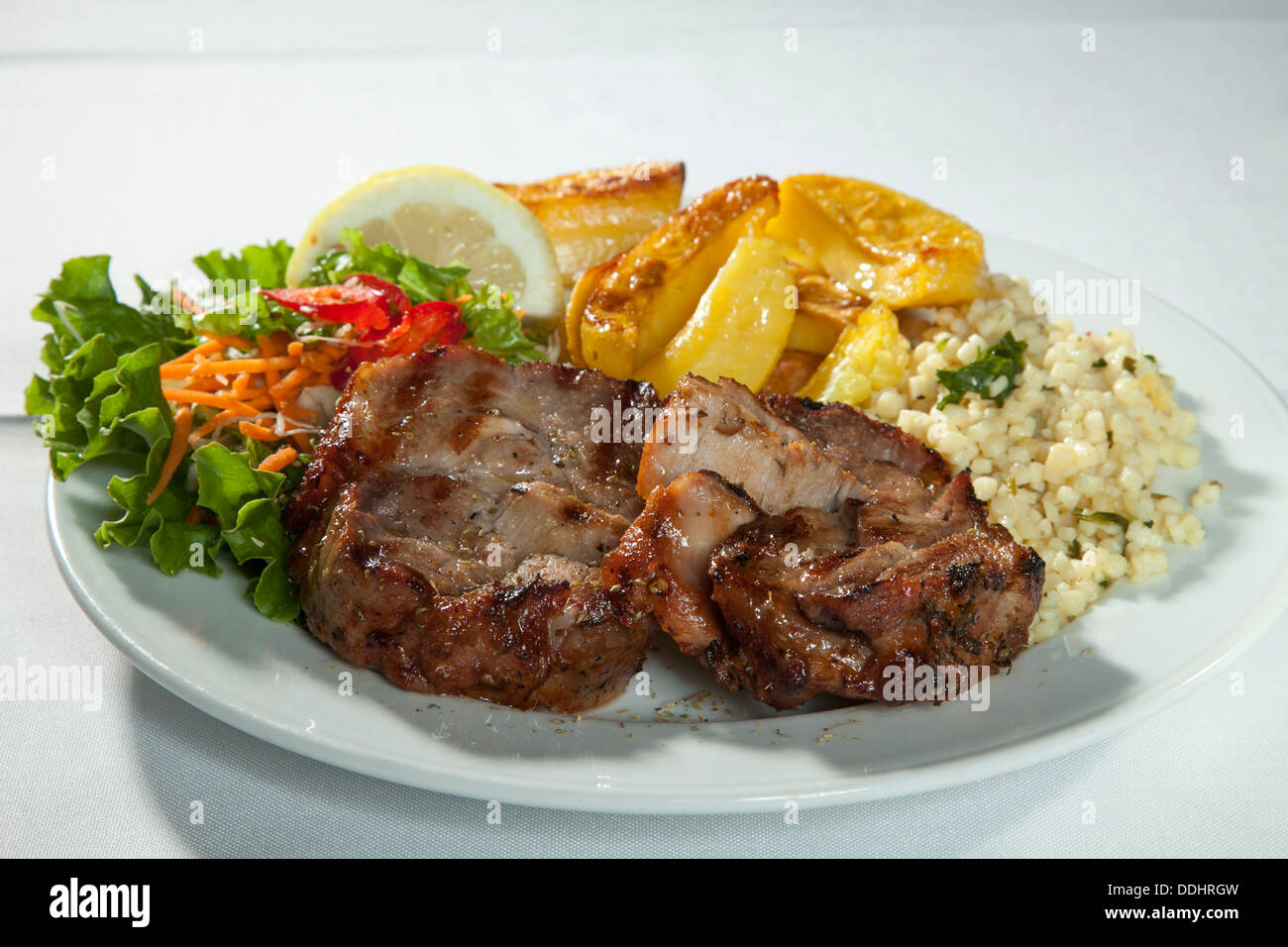 Beef chicken pork meat cooked grilled served with rice potatoes red and ...