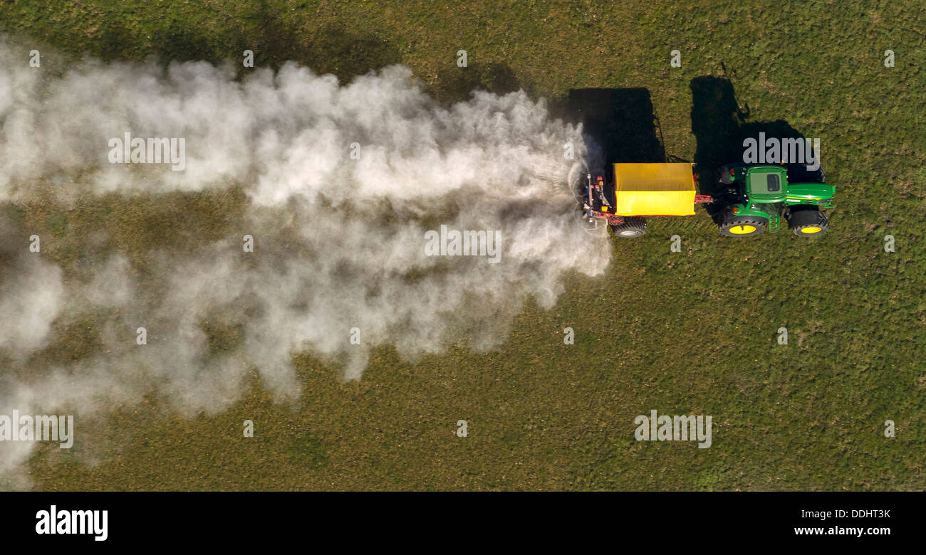 Aerial view, tractor liming a meadow Stock Photo - Alamy