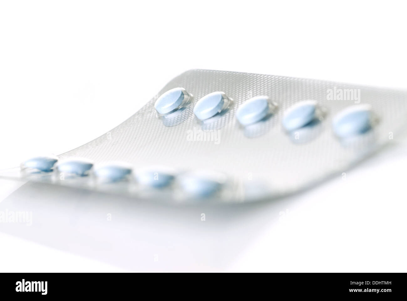 pack of blue tablets isolated on white Stock Photo - Alamy