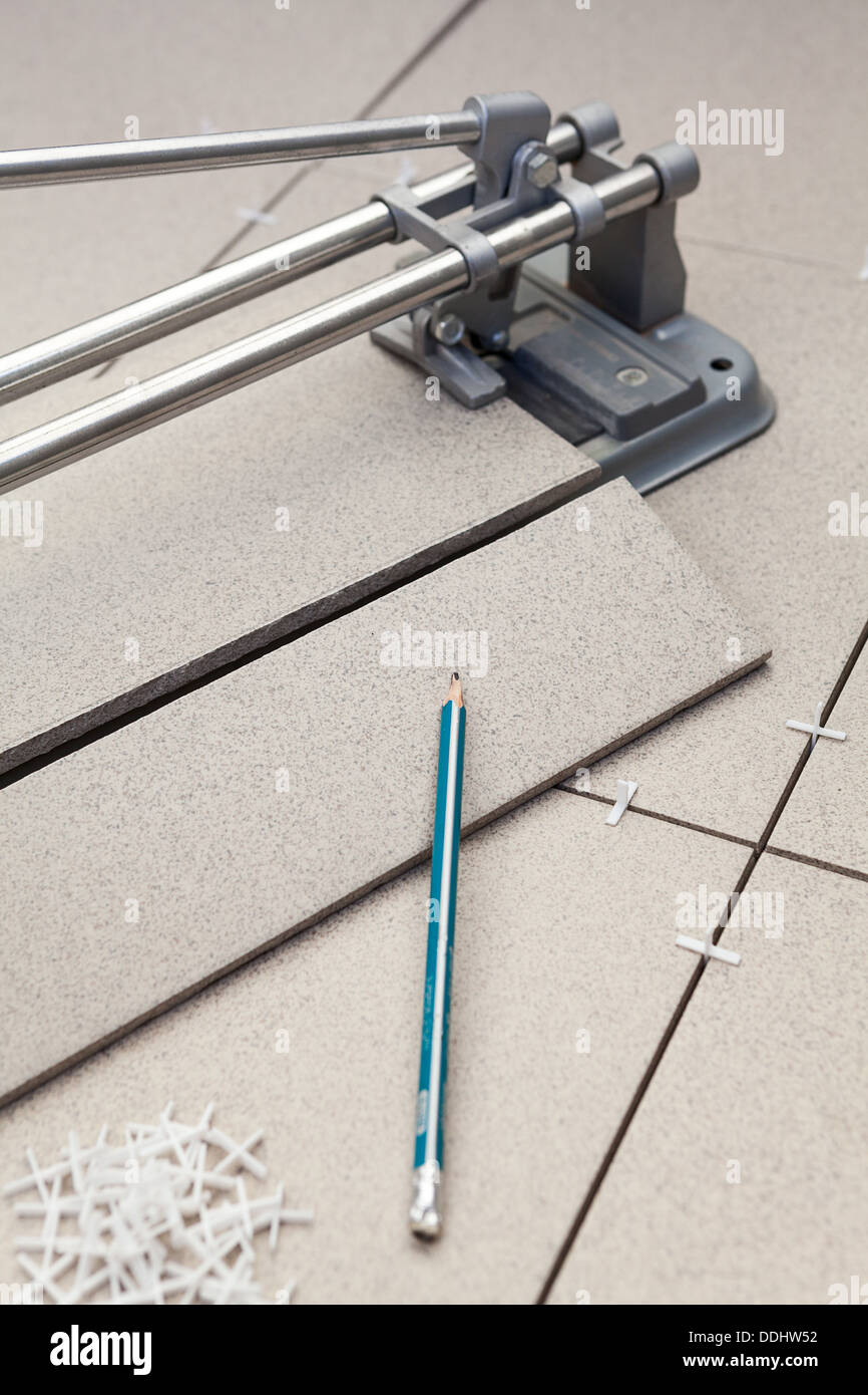 Tiles cutting works with Pre-laying porcelain Stock Photo - Alamy