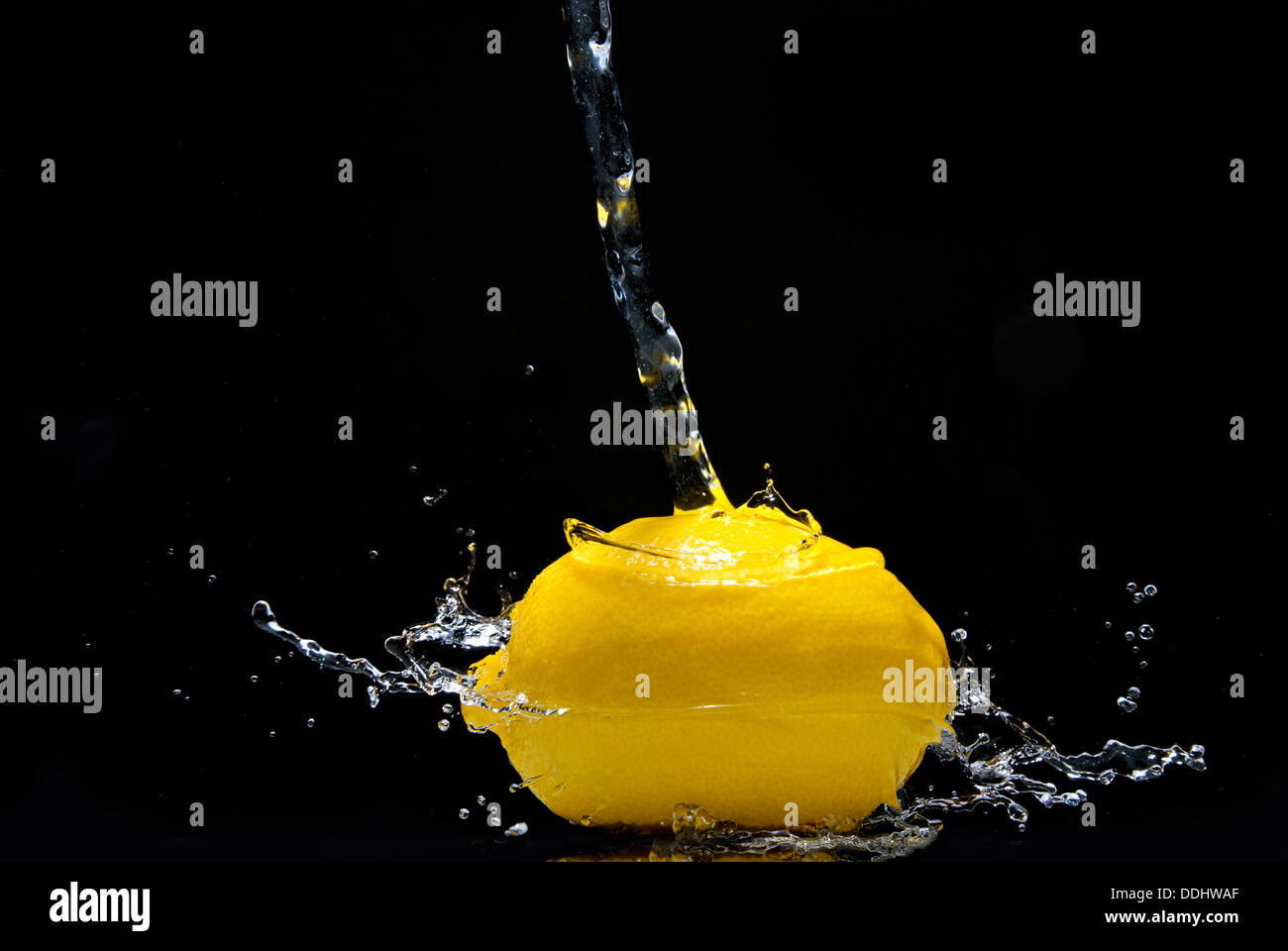 Fresh lemon and water splash isolated on black Stock Photo - Alamy