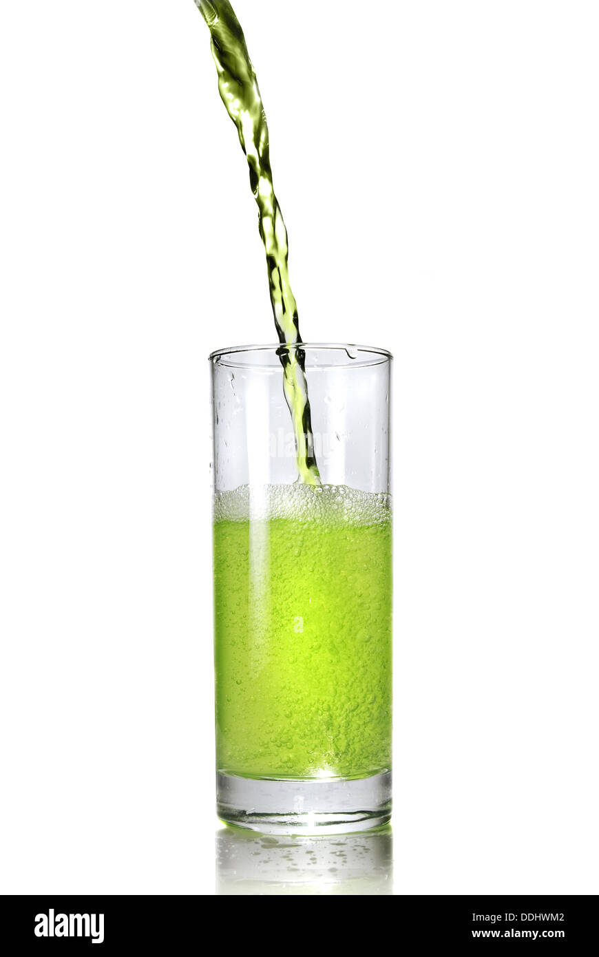 green juice pouring into glass isolated on white Stock Photo - Alamy