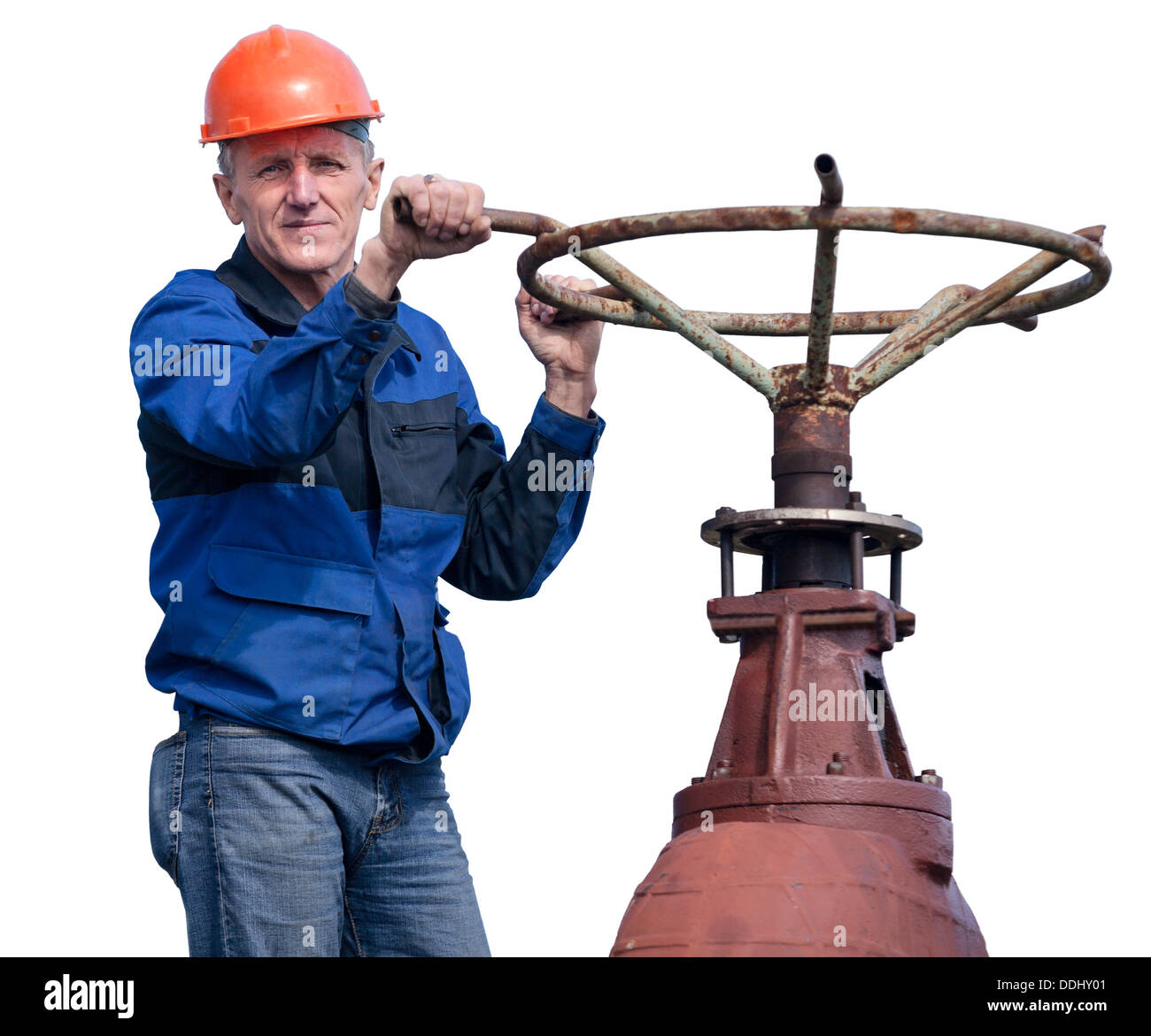 Senior workman turning huge valve gate at factory isolated on white ...