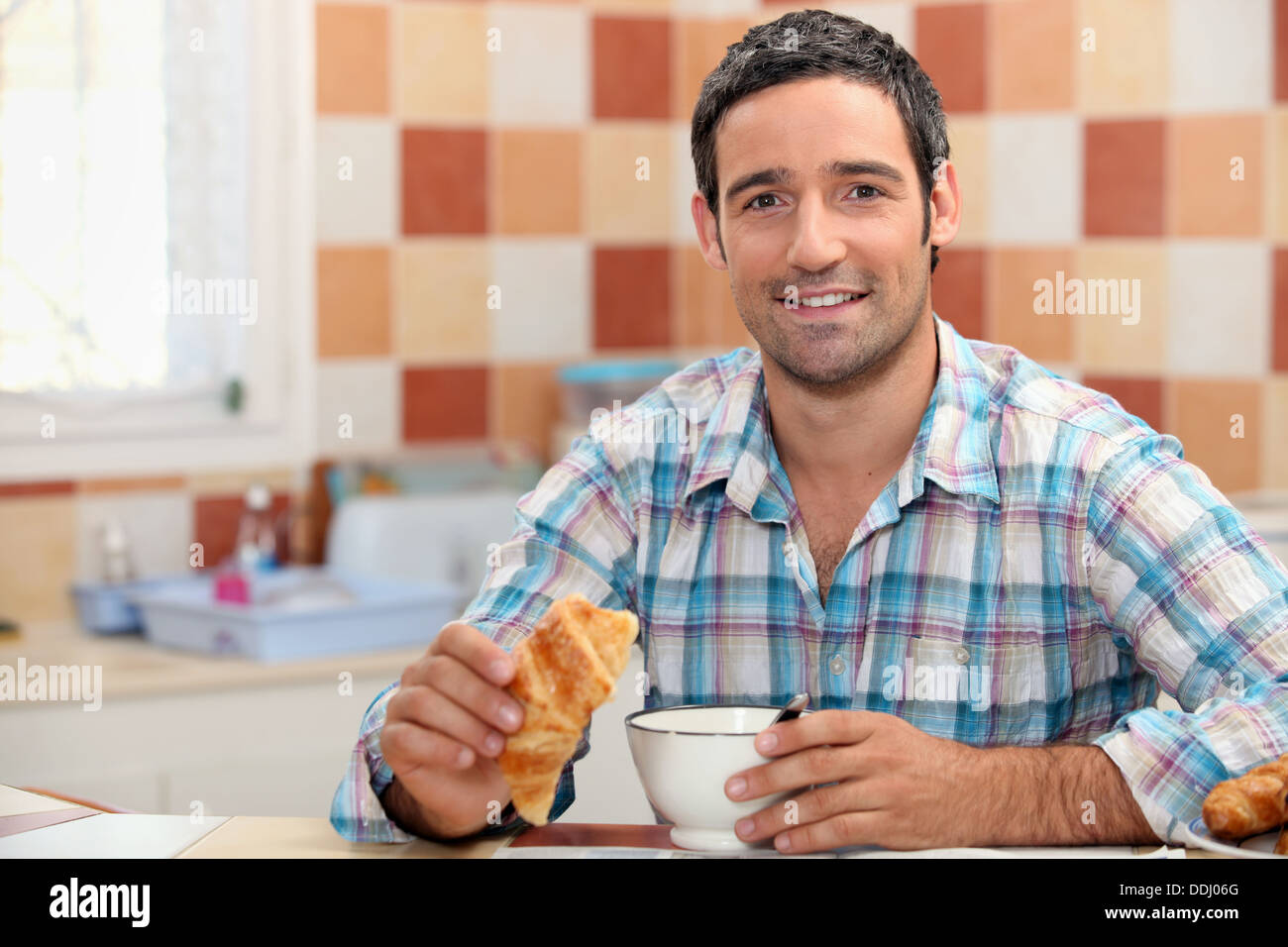Man eating a continental breakfast Stock Photo - Alamy
