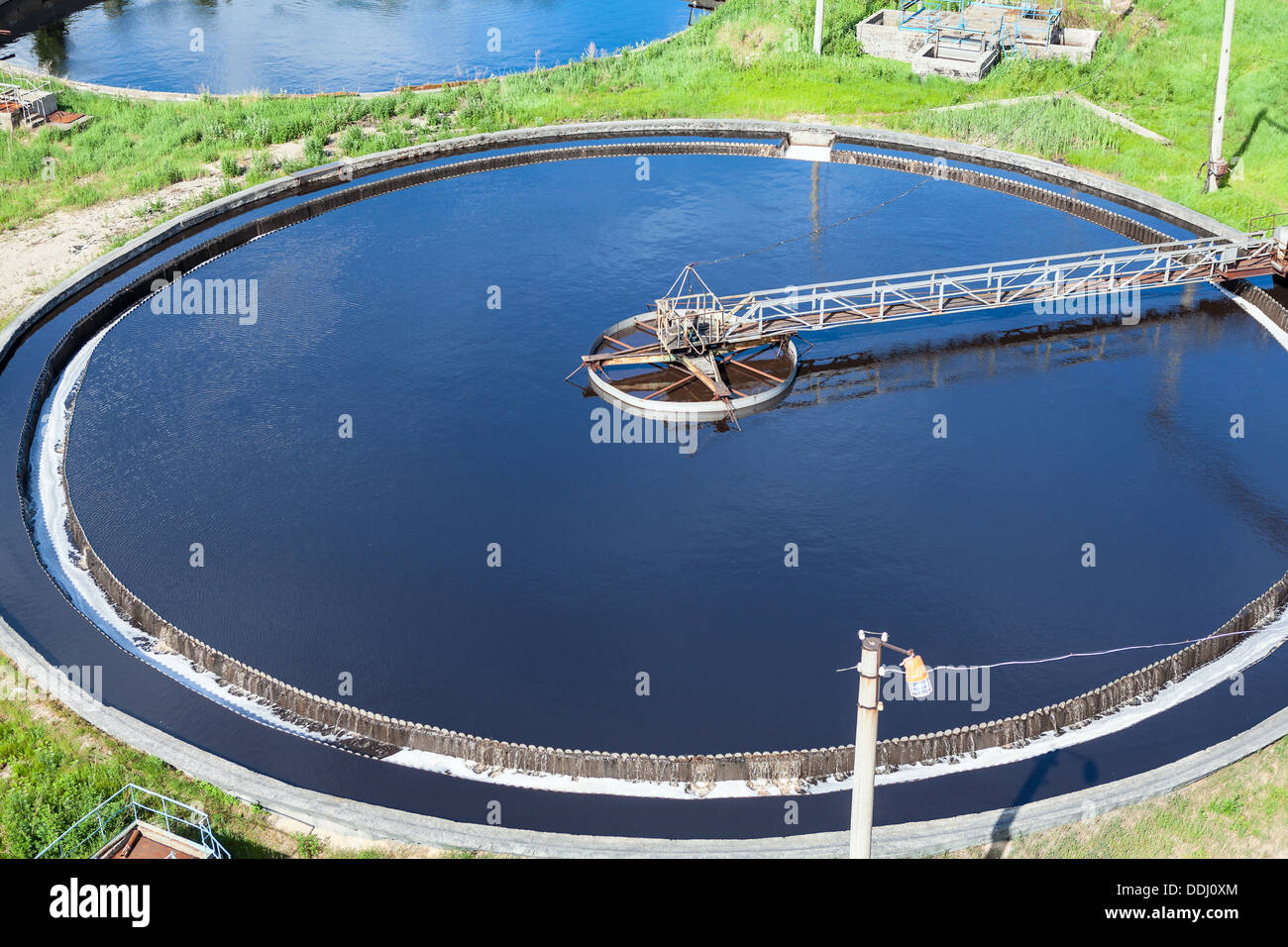 Primary round sedimentation basin, sewage flowing through large tanks ...