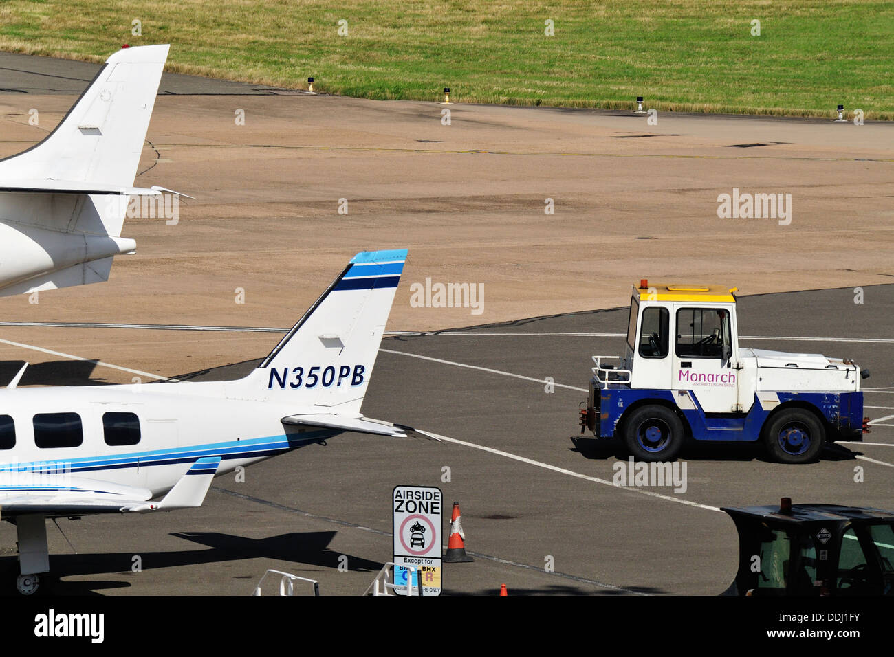 Tails of small aircraft and a tug on the apron of the old Elmdon ...