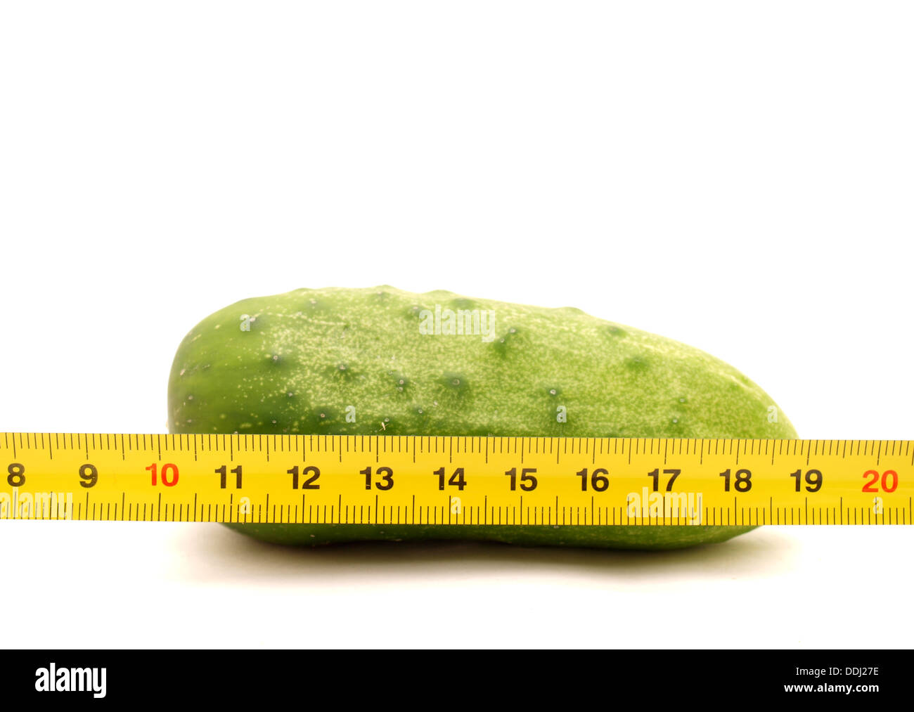 Cucumbers and ruler on a white background Stock Photo - Alamy