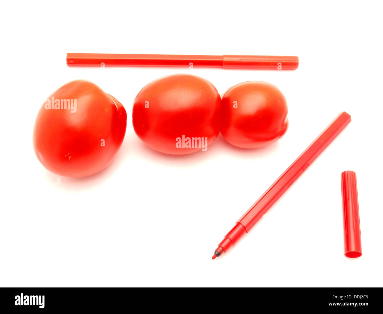 Tomatoes and felt-tip pens on a white background Stock Photo - Alamy