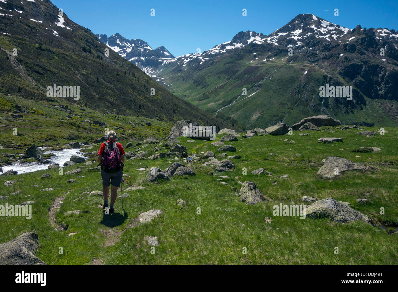 Female figure in red walking in French Pyrenees Stock Photo - Alamy