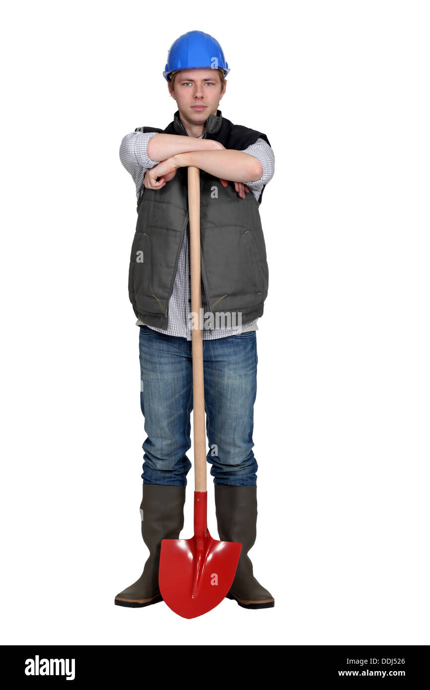 Man stood with shovel Stock Photo - Alamy