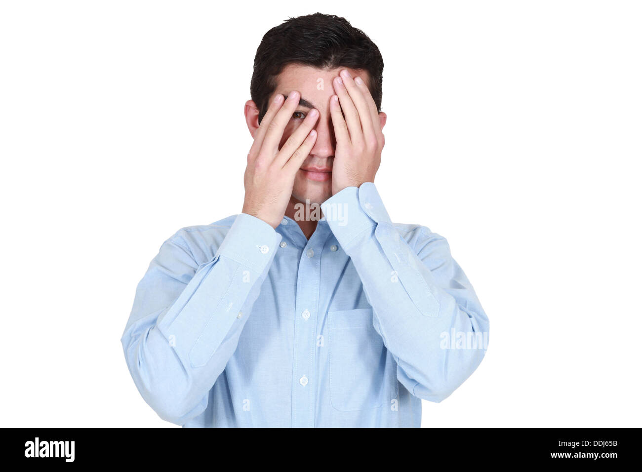 Young man covering eyes Stock Photo - Alamy