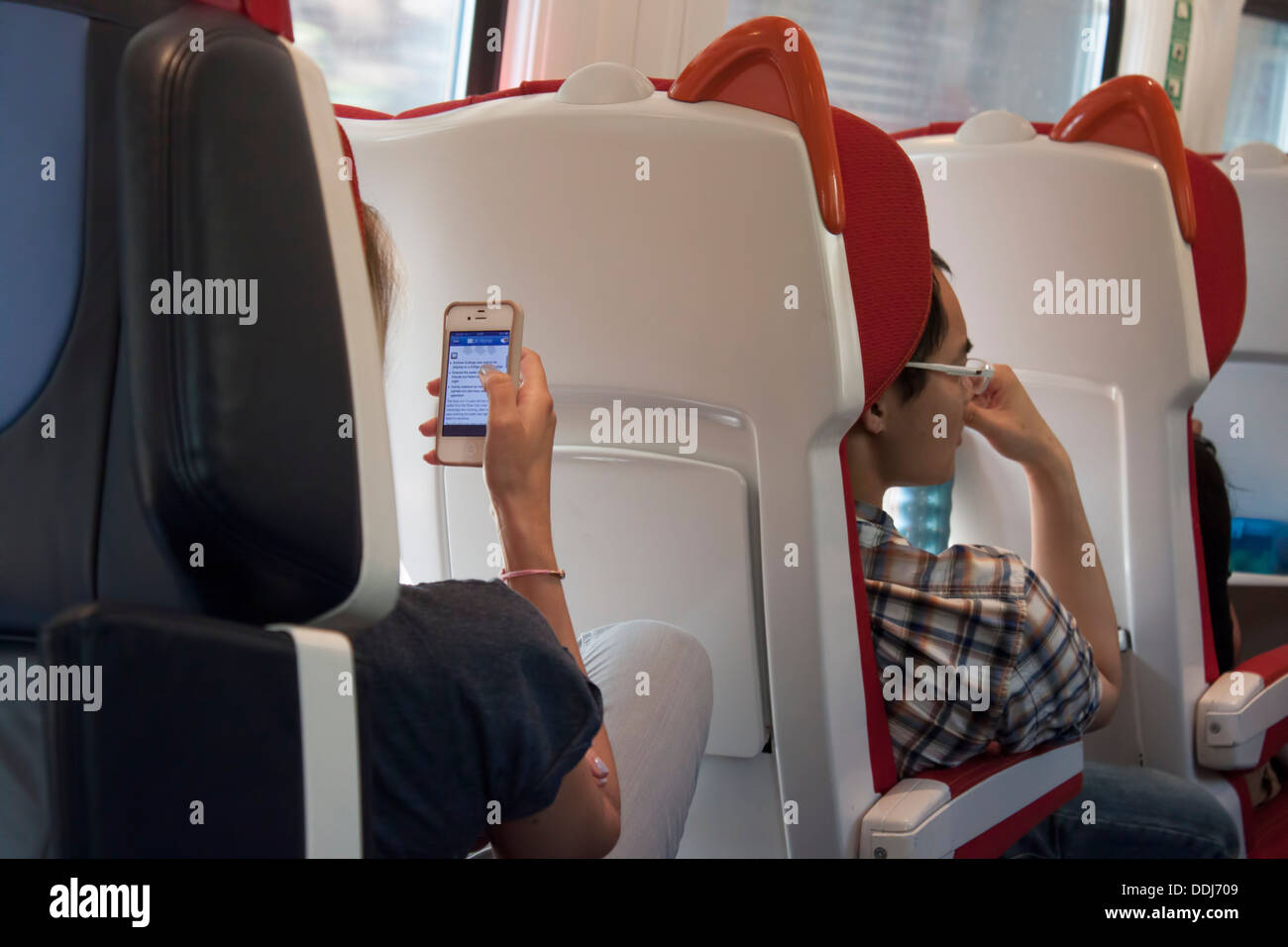 Passengers working on train Stock Photo - Alamy