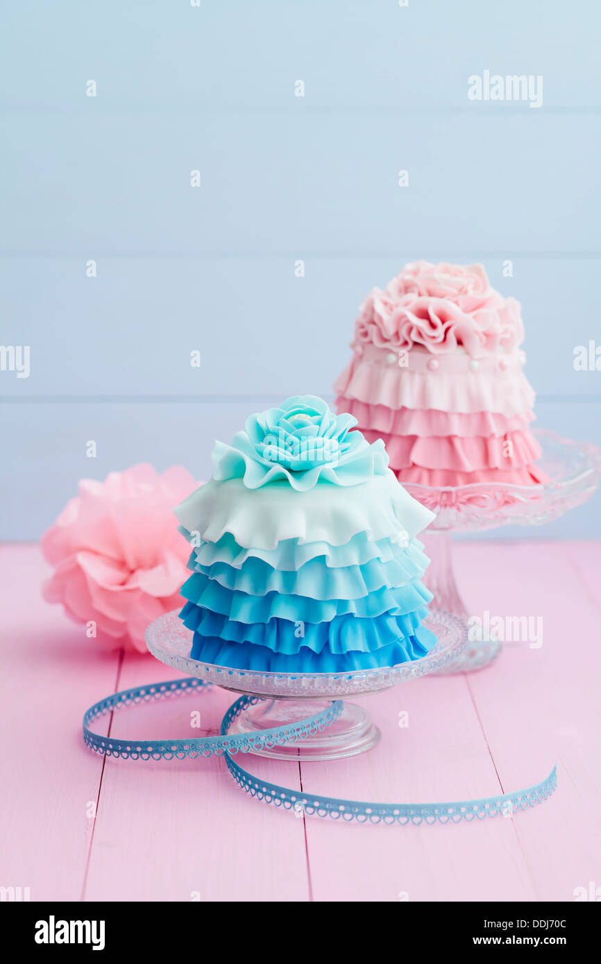 Pink and light blue mini cake on cake stand, close up Stock Photo - Alamy