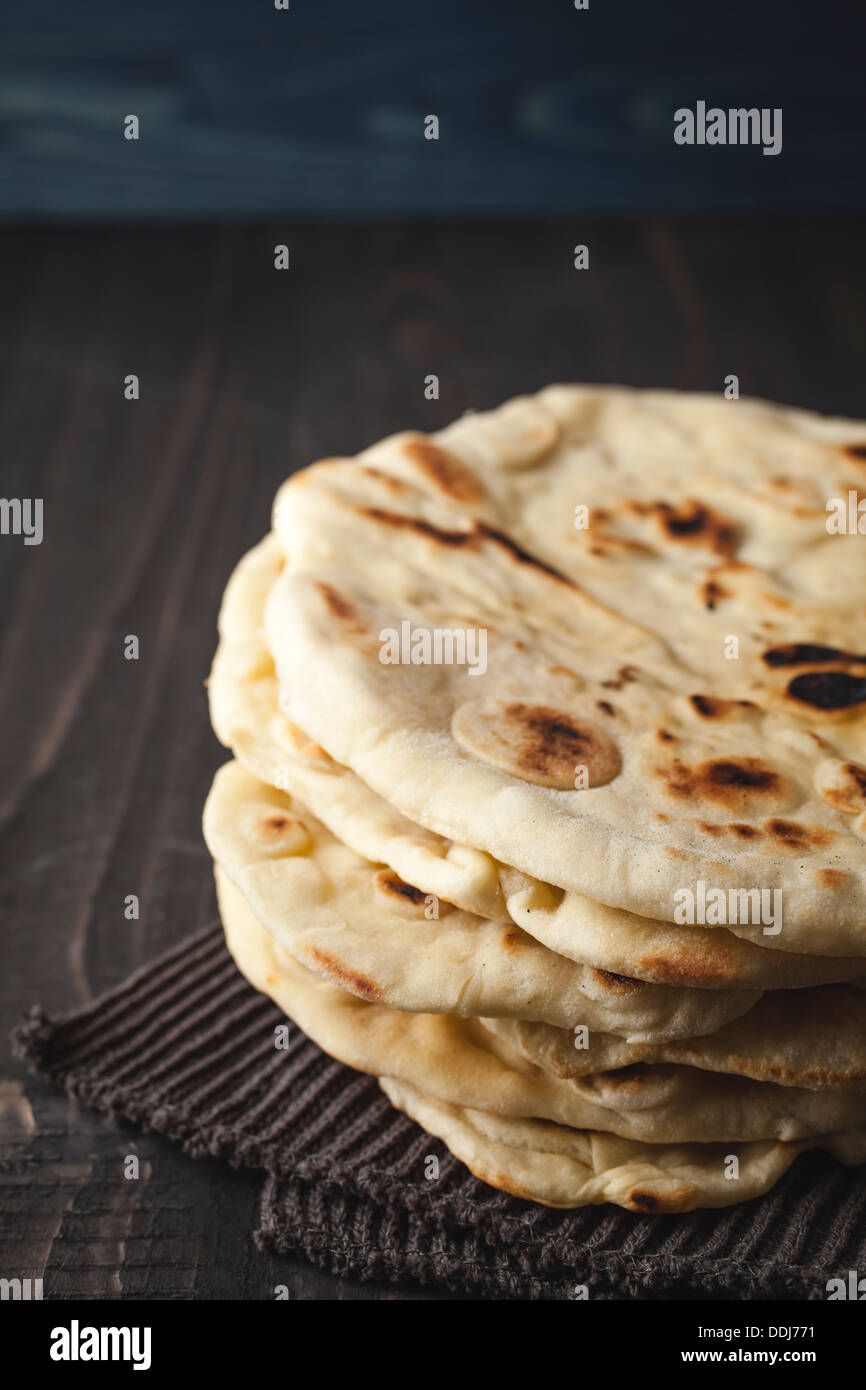 Stack of flat breads on wooden table, close up Stock Photo - Alamy