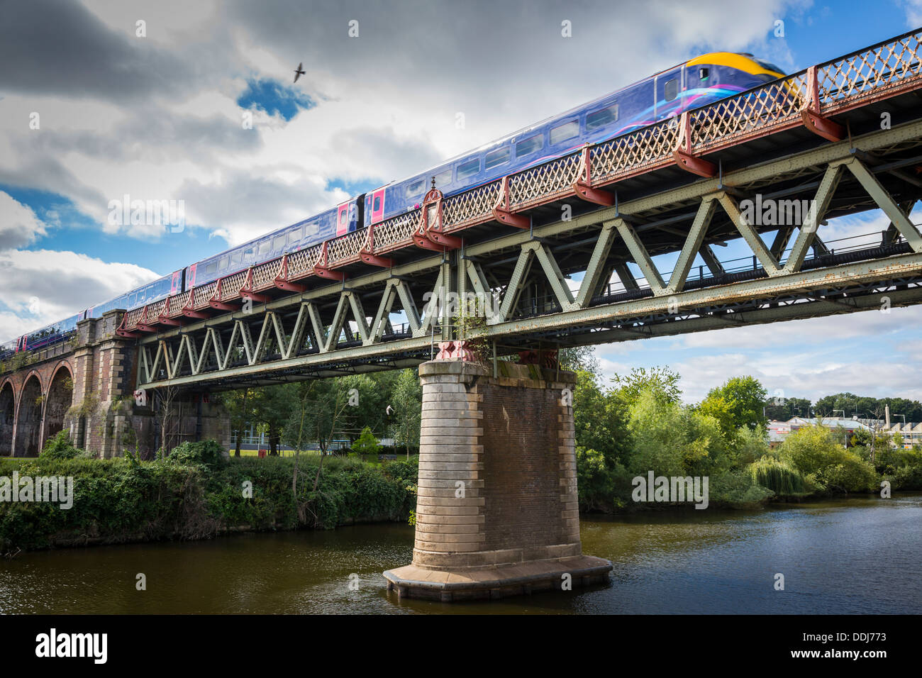 Worcester viaduct over the river Severn with passenger train crossing ...